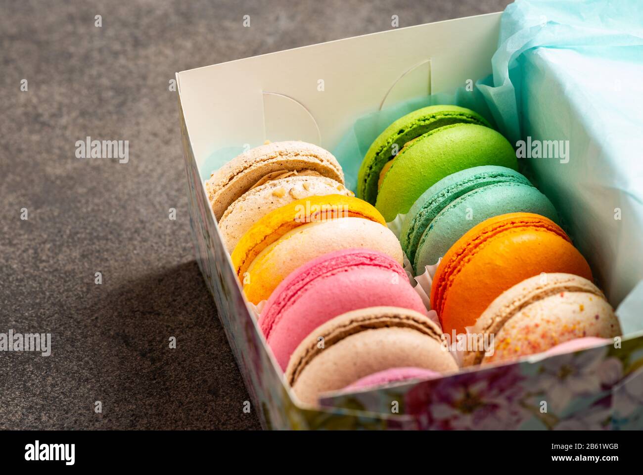 Multi-colored macaroons with different tastes in a gift box. Close-up ...