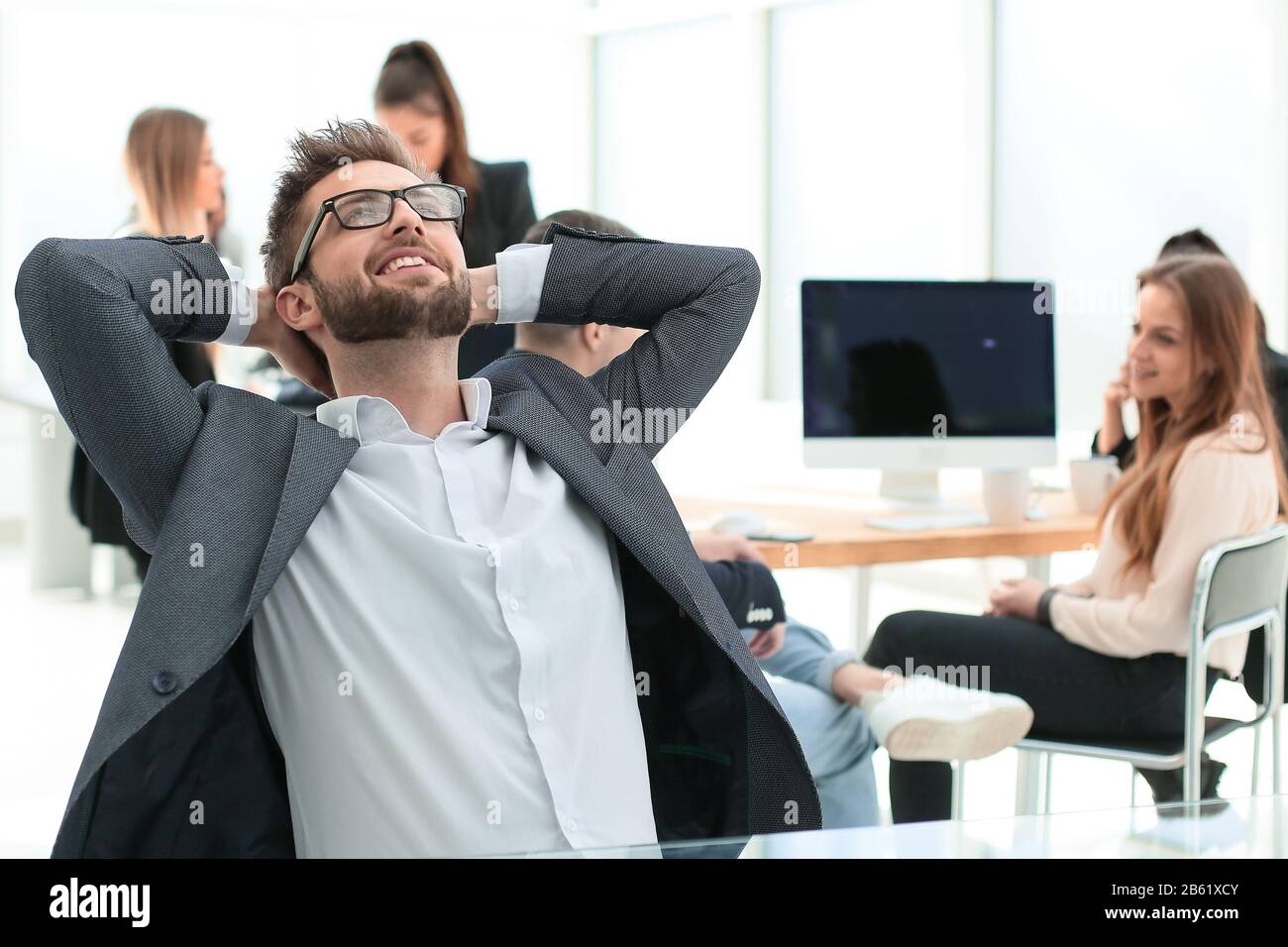 brooding young businessman sitting at an office Desk Stock Photo - Alamy