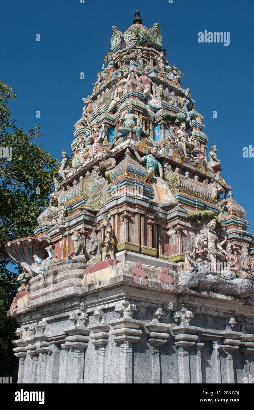 Gopuram top against blue sky background. Gopuram (Gopura (singular)) is ...