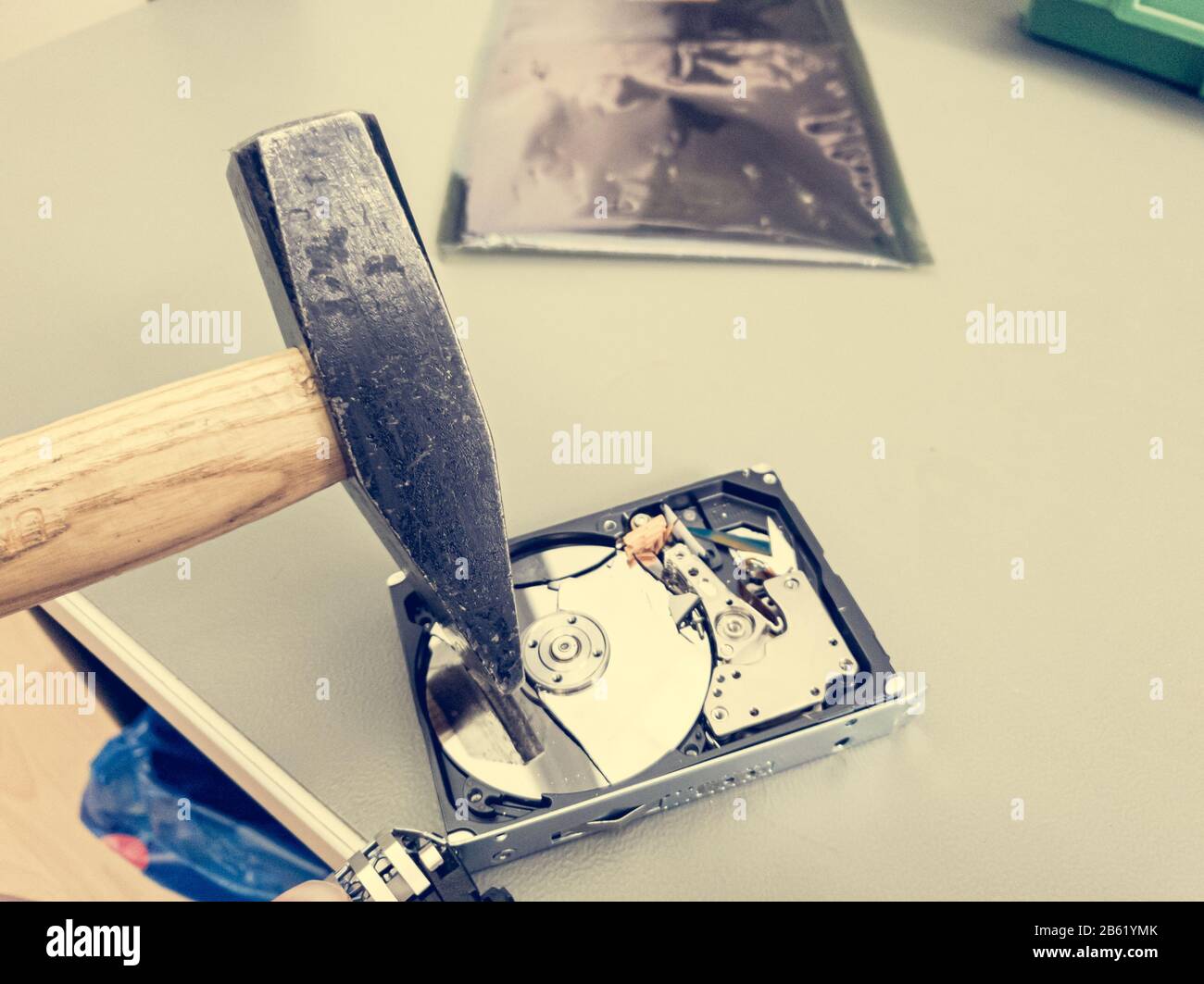 Destroying computer hard drive with a hammer Stock Photo - Alamy