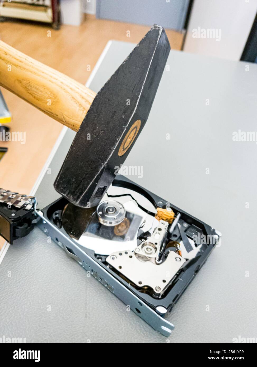 Destroying computer hard drive with a hammer Stock Photo - Alamy