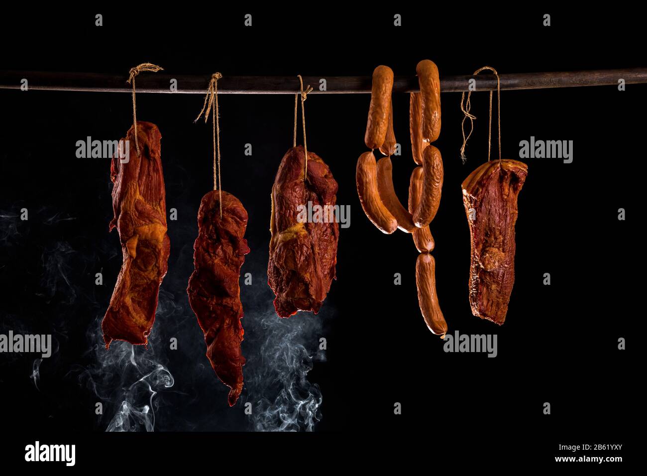 Smoked ham, bacon, pork neck and sausages in a smokehouse Stock Photo ...