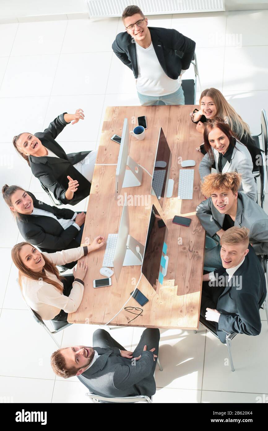 top view. group of employees sitting around an office Desk Stock Photo ...