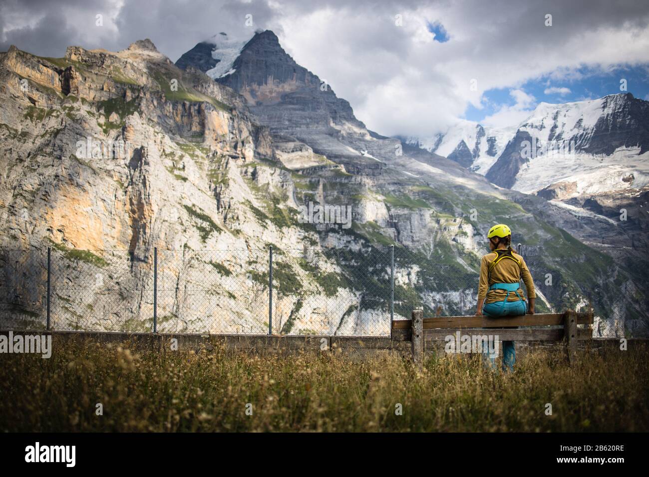 Pretty, female climber on a via ferrata - climbing on a rock in Swiss ...