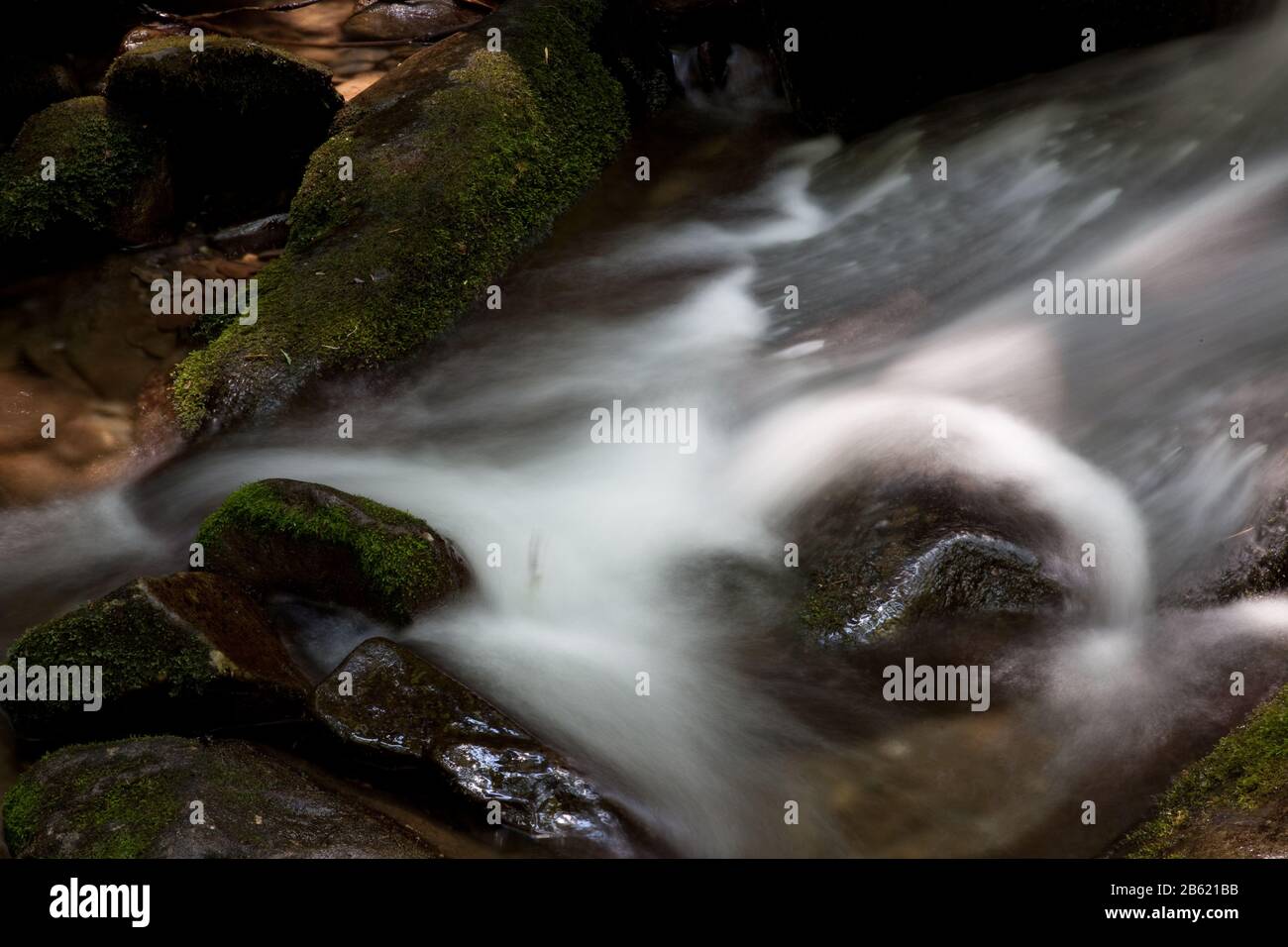 Water cascading over rocks outdoors Stock Photo - Alamy