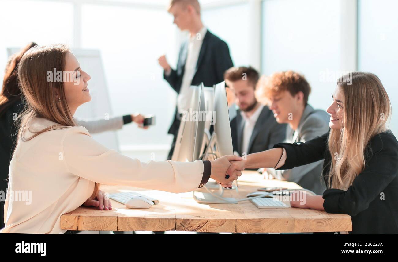 young employees shaking hands at a successful presentation Stock Photo ...