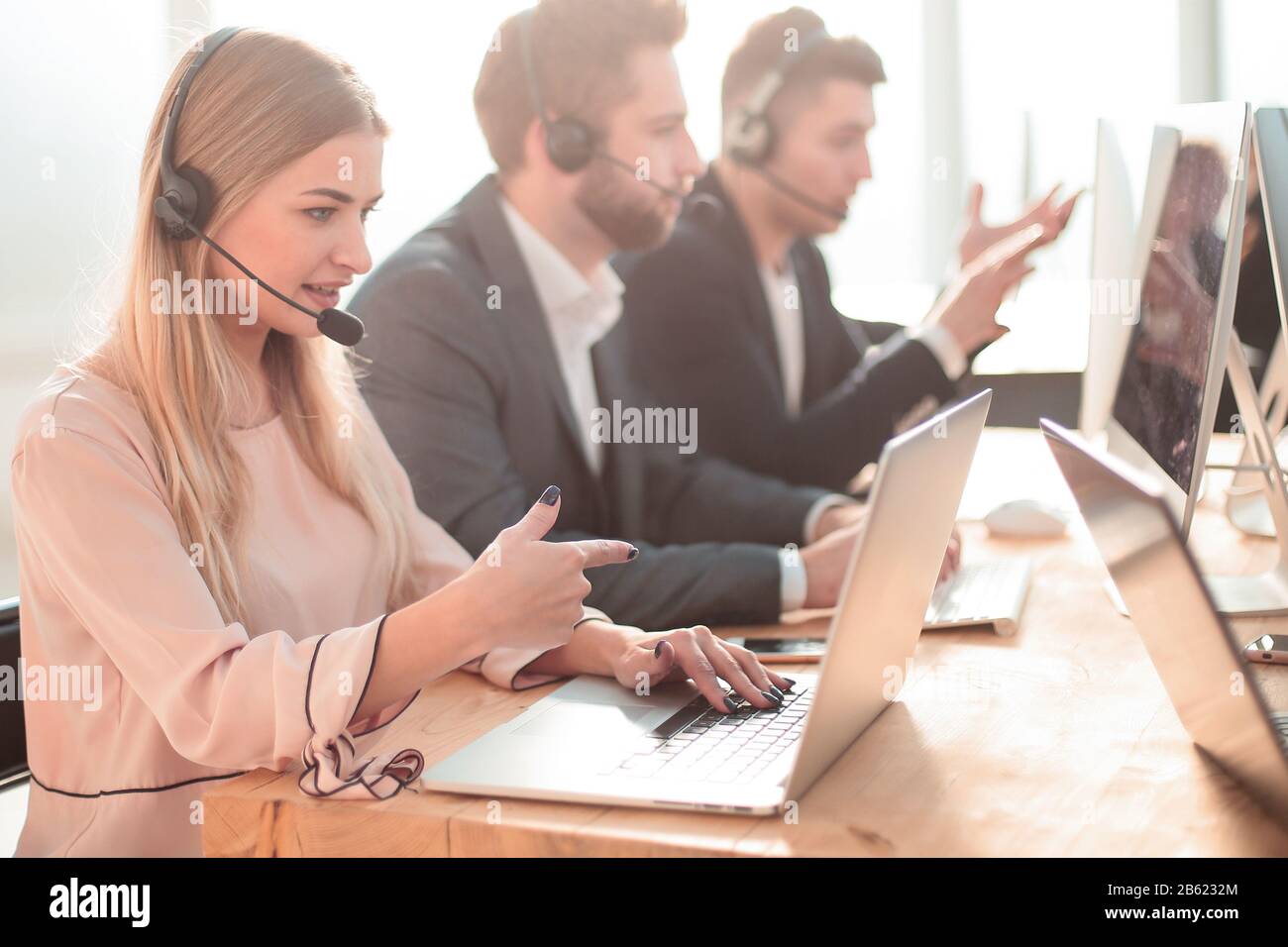 call center employees using computers to work with clients Stock Photo ...