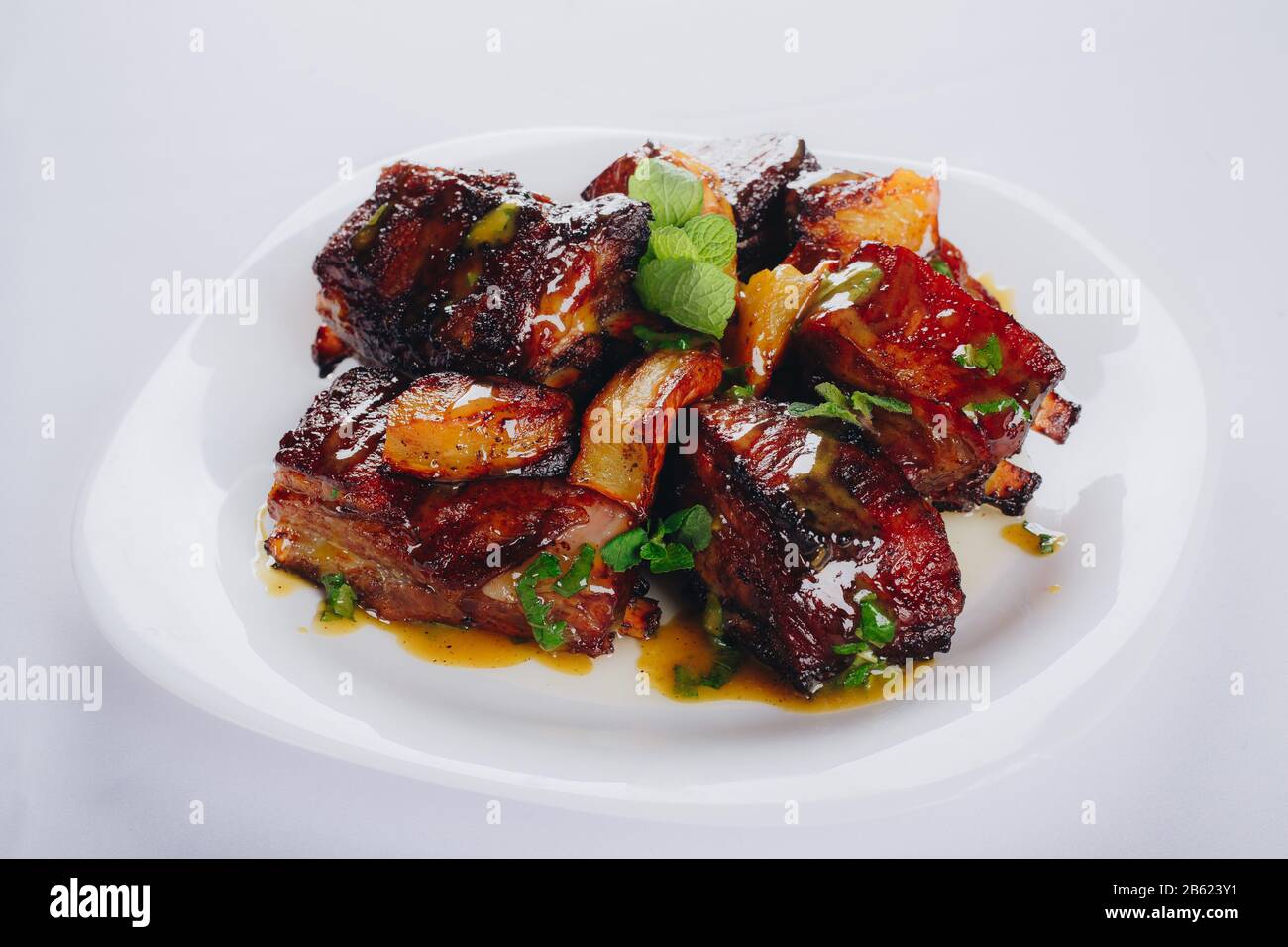 Baked pork ribs in honey sauce Stock Photo - Alamy