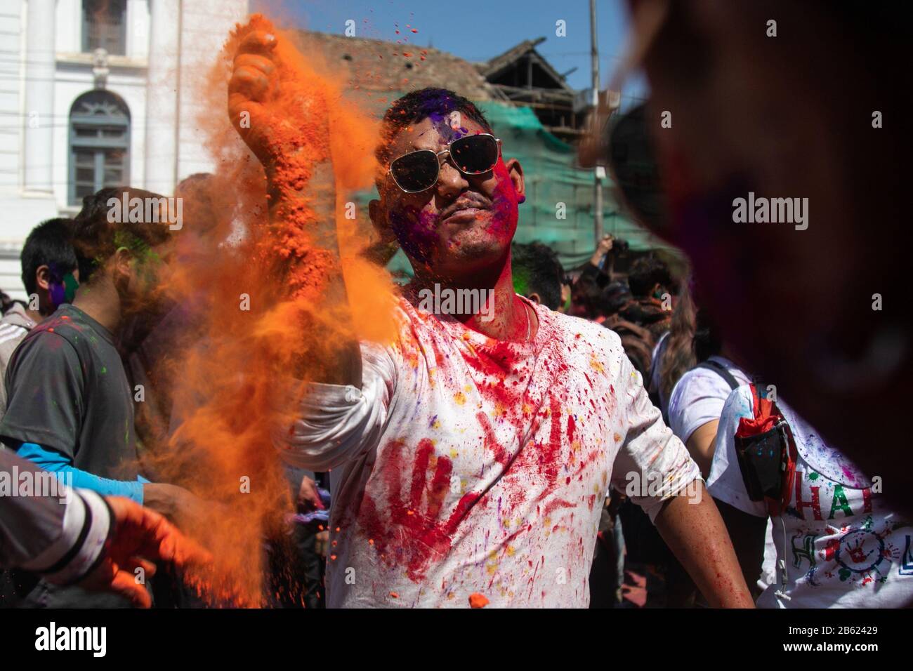 Kathmandu, Nepal. 09th Mar, 2020. A man throw vermilion powder during a ...
