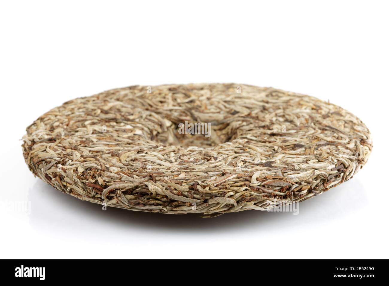 Disc of Chinese pu erh tea shot on white background Stock Photo - Alamy