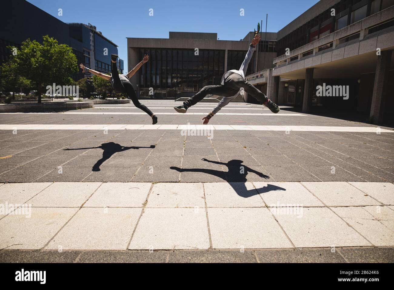Caucasian men jumping on the street Stock Photo - Alamy
