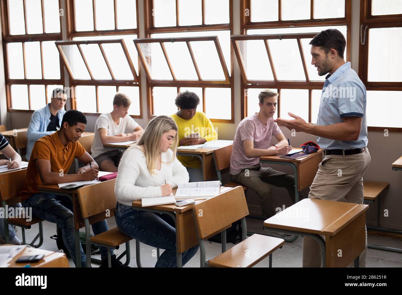 Side view of students working in class Stock Photo - Alamy