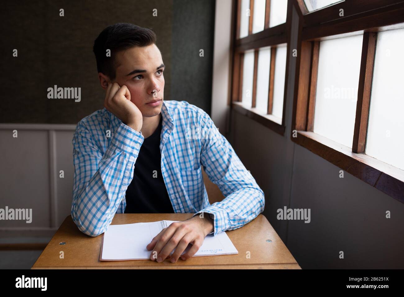 Front view of student looking through the window Stock Photo - Alamy