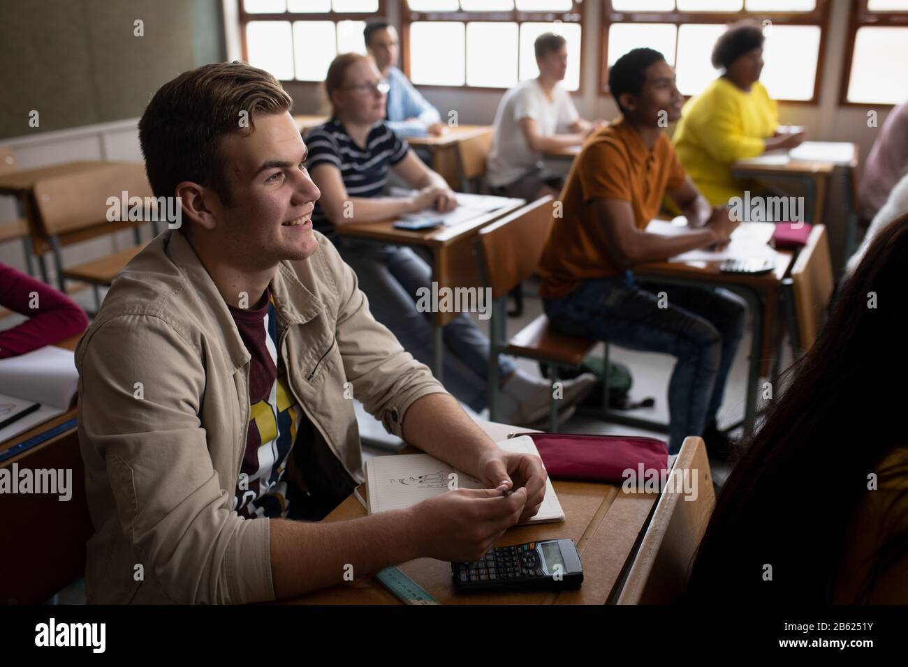 Side view of students listening in class Stock Photo - Alamy