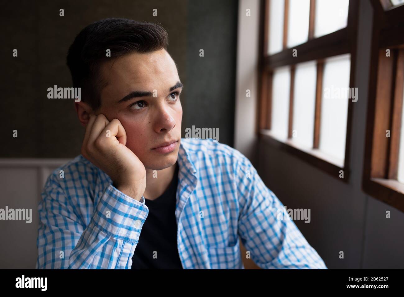 Front view of student looking through the window Stock Photo - Alamy