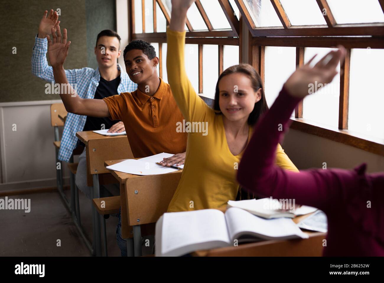 Students raising their hands hi-res stock photography and images - Alamy
