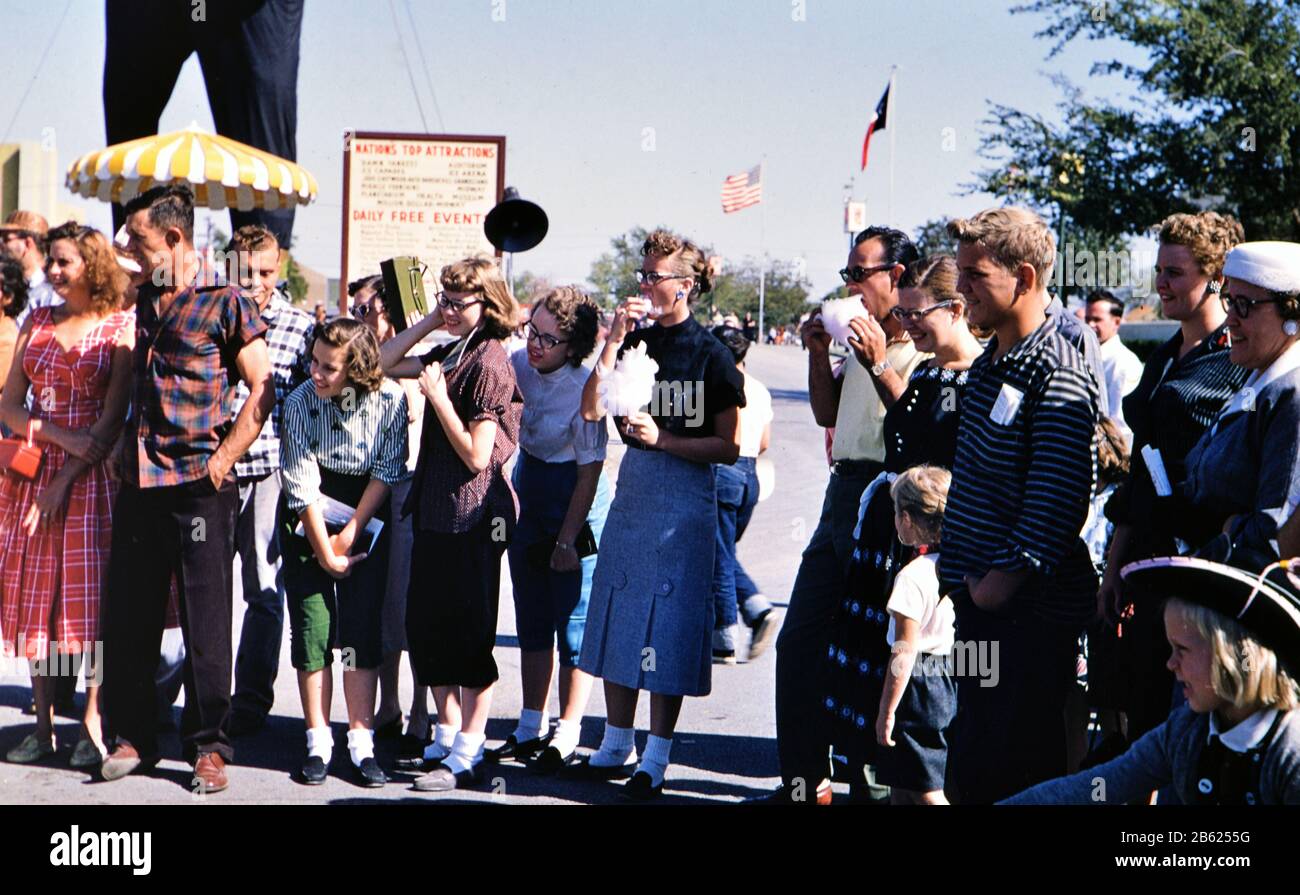 A crowd at the Texas State Fair (a few eating cotton candy) ca. 1954 ...