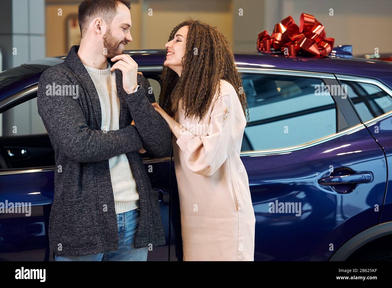 funny cunning woman trying to pursuading her boyfriend to buy a car ...
