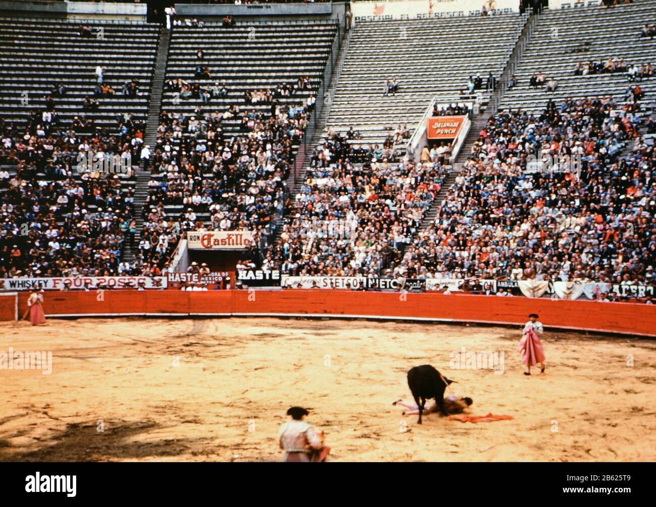 Half filled stadium of spectators watch a bull fight in Mexico ca. 1950 ...