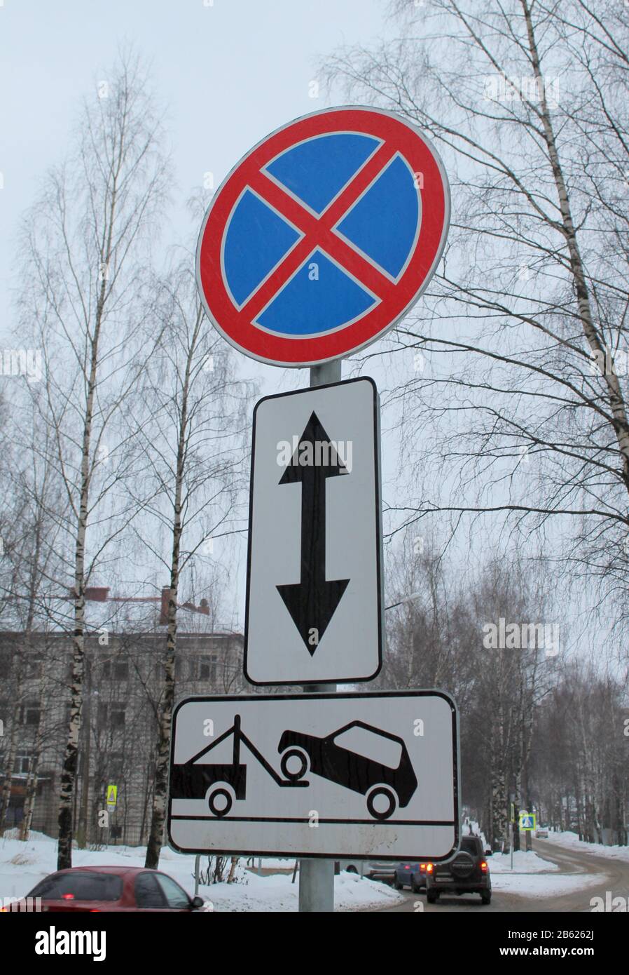 Traffic signs stop is prohibited, a tow truck is working, an arrow with ...