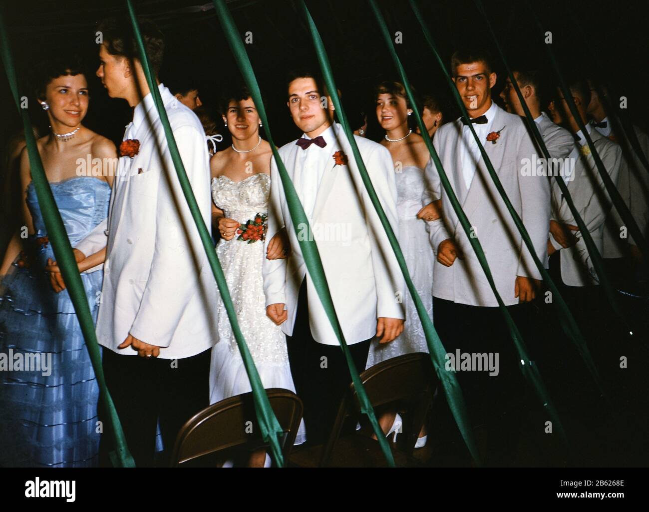 Girls and boys (probably high school) dressed for a formal dance ca ...