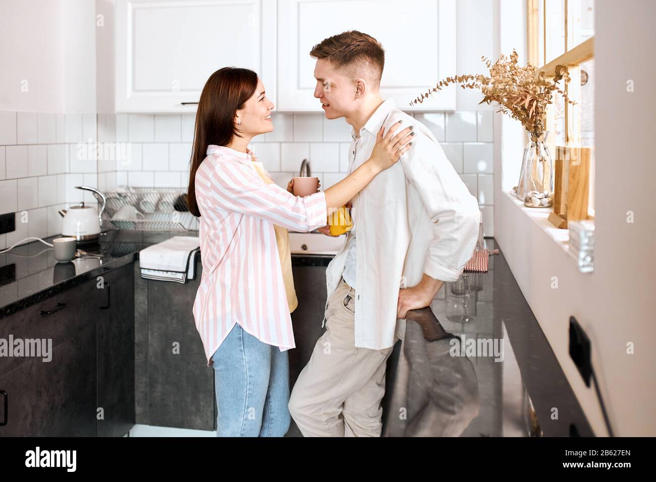 cheerful attractive family having conversation in the kitchen, close up ...