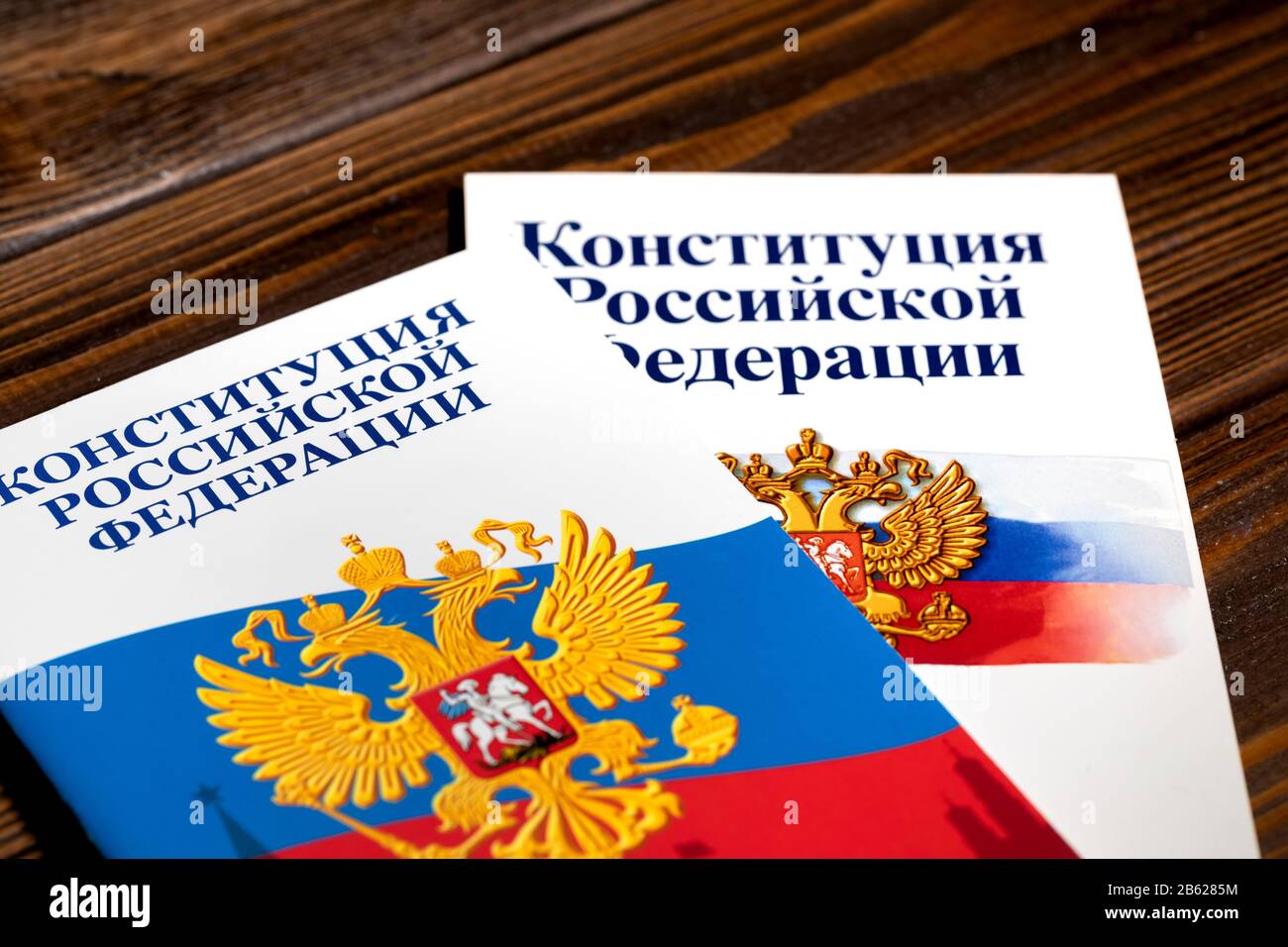 Brochures "Constitution of the Russian Federation" are on a wooden ...