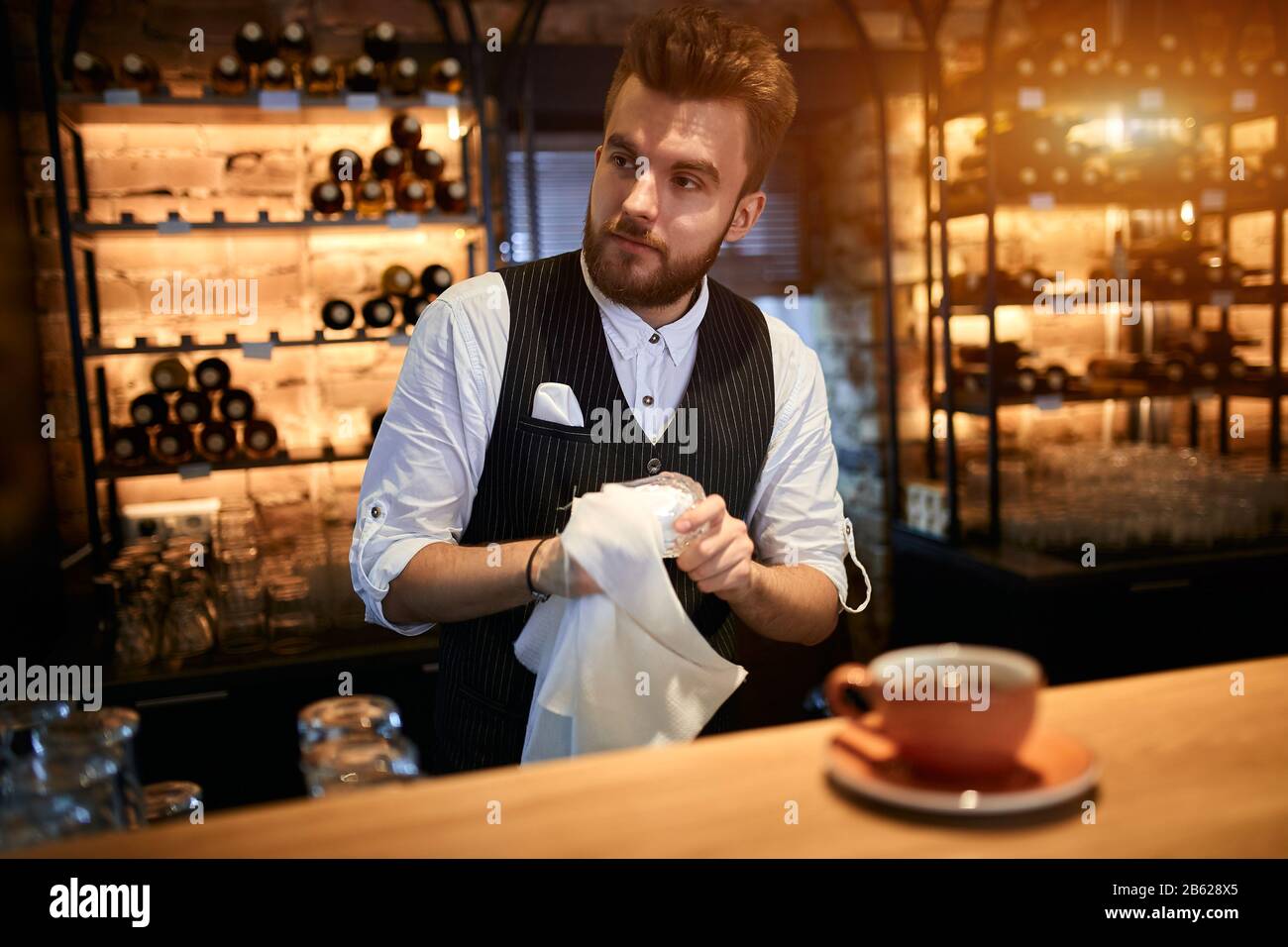 Bar man cleaning glasses hi-res stock photography and images - Alamy