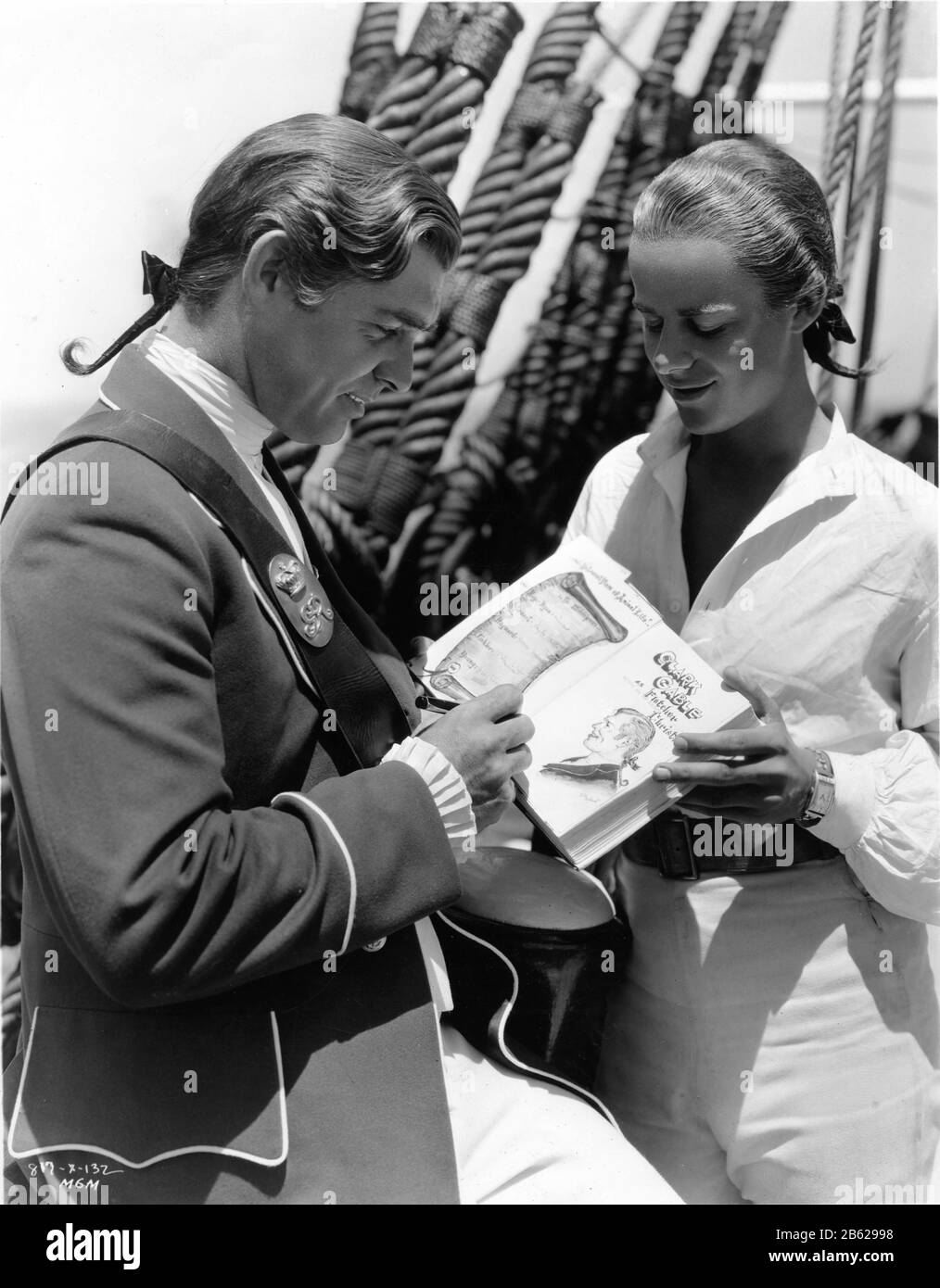 CLARK GABLE in costume as Fletcher Christian signs portrait of himself ...