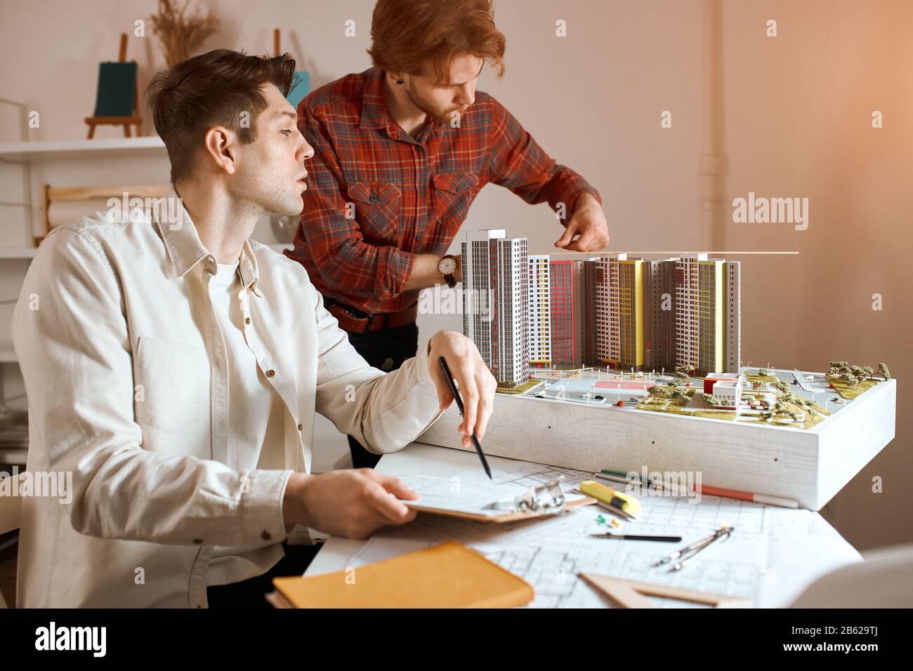 young handsome men working on architectural urban project, planning ...