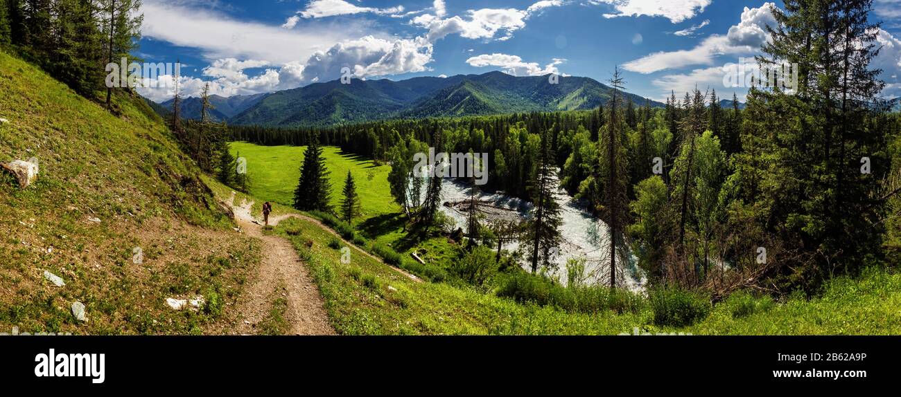 panorama with mountains meadow and forest river and one hiker Stock ...
