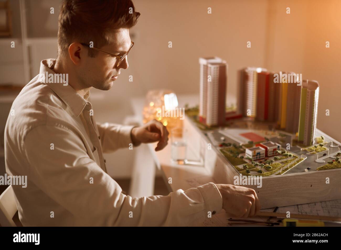 young man is responsible for designing, building houses, places, close ...