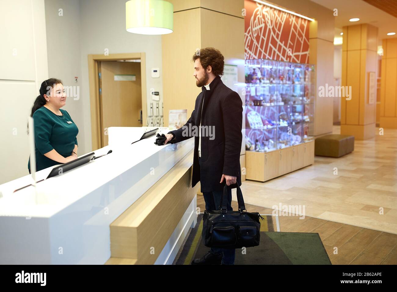 serious bearded man talking with the receptionist, conversation ...