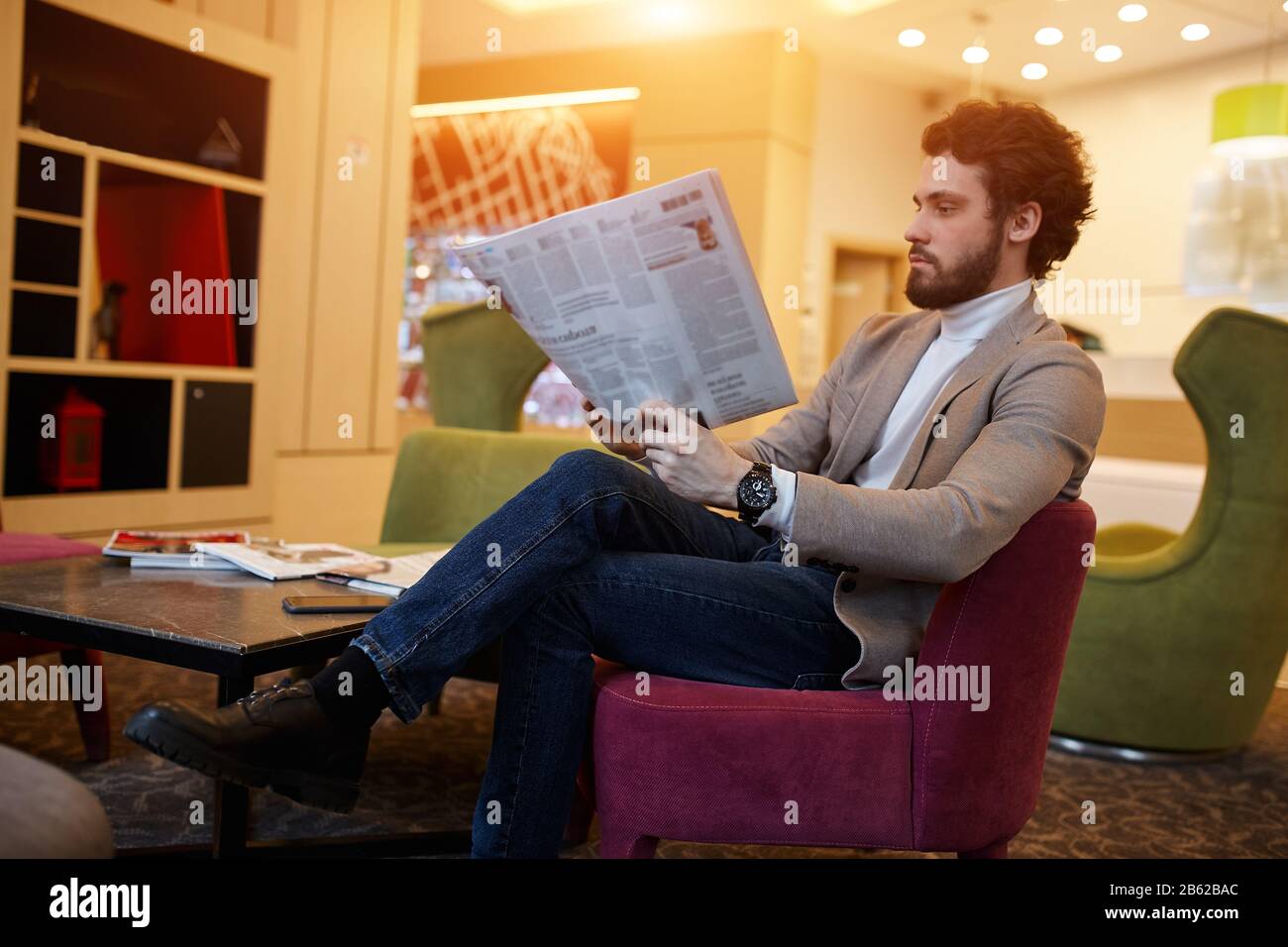 Successful businessman reading magazine hi-res stock photography and ...