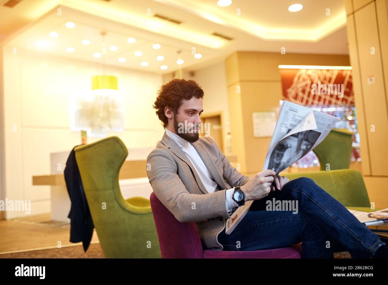 Successful businessman reading magazine hi-res stock photography and ...
