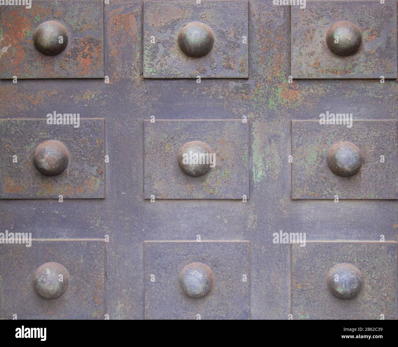 rusty iron plate with rectangular designs and studs in relief.texture ...