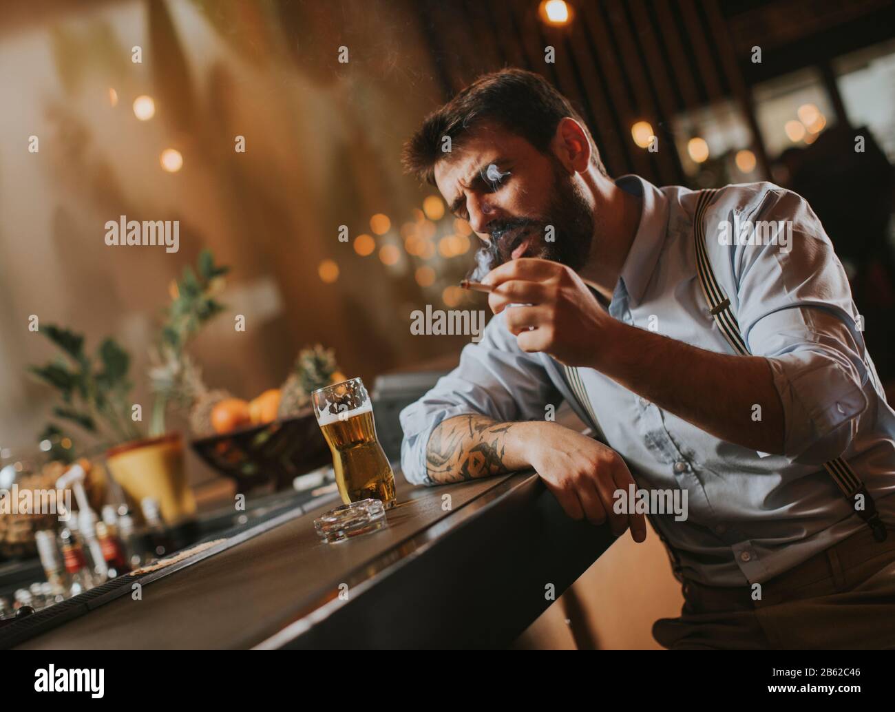Handsome guy smoking cigar bar hi-res stock photography and images - Alamy
