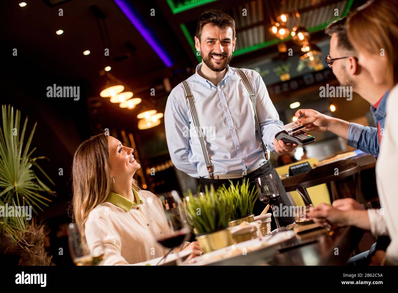 Woman group people paying bill cafe hi-res stock photography and images ...