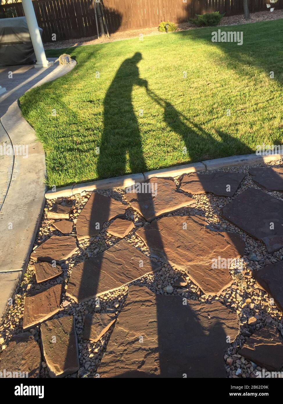Shadow of Man Pushing Lawn Mower Over Grass Stock Photo - Alamy