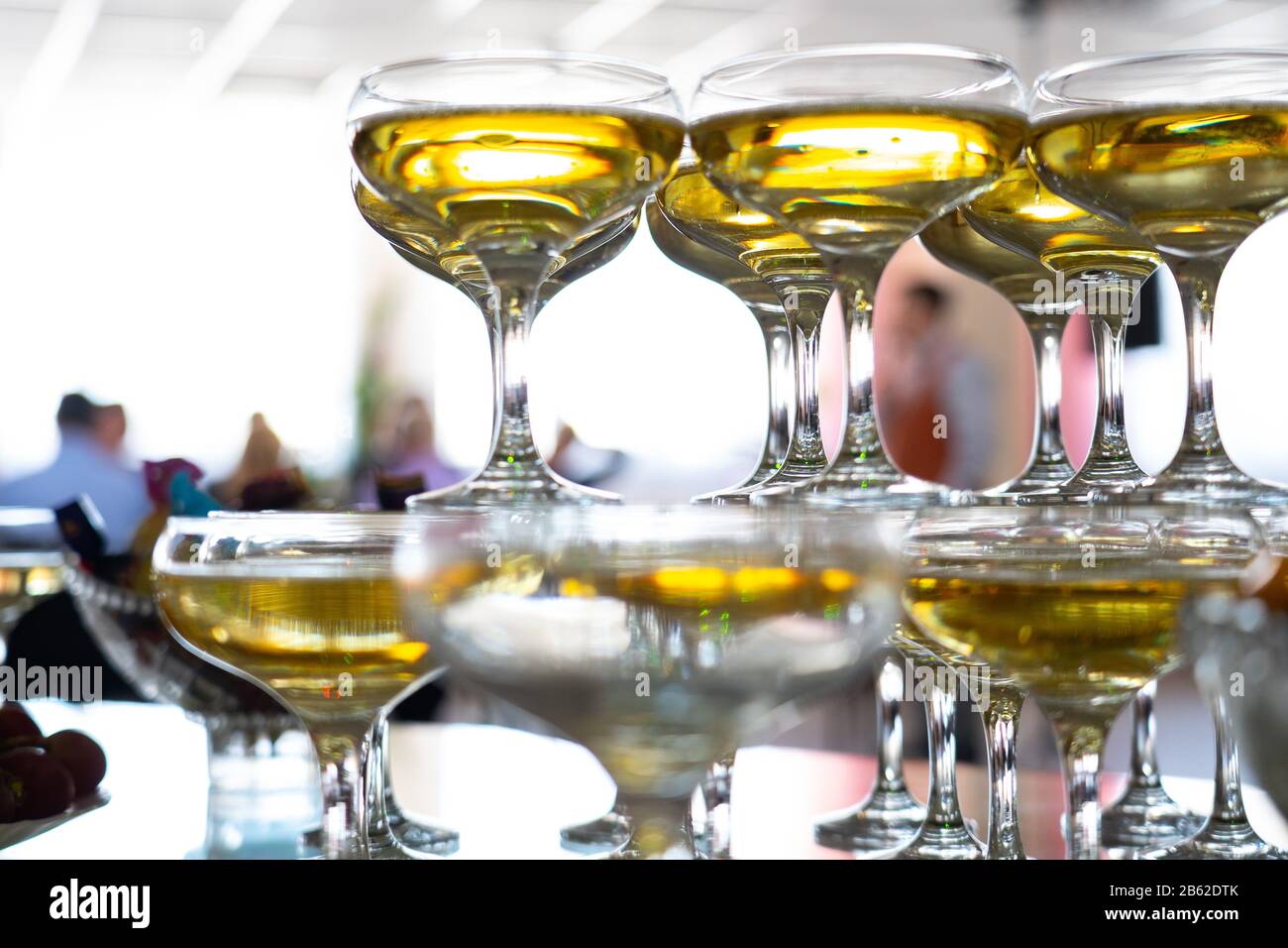 A pyramid of glasses of champagne. White sparkling wine in glasses ...