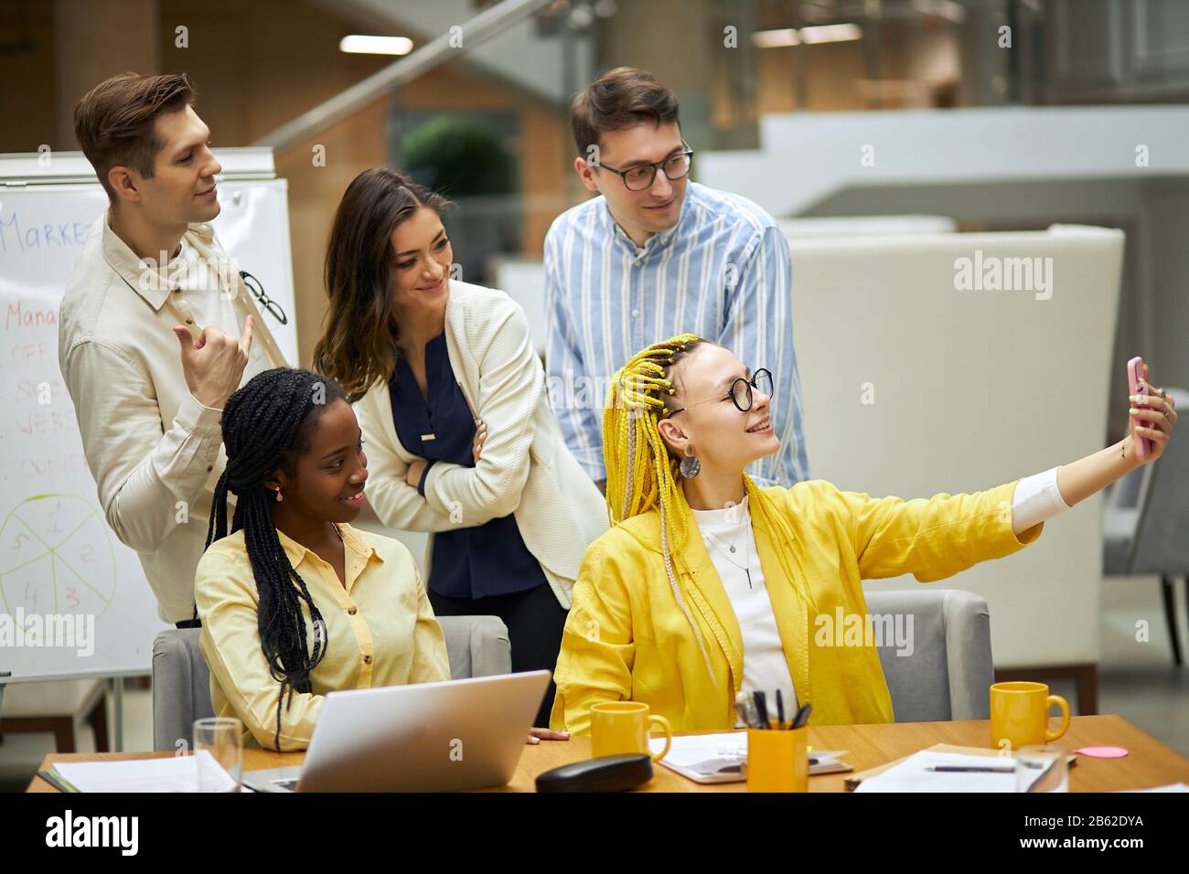 good looking business people having photo session at workplace. pretty ...