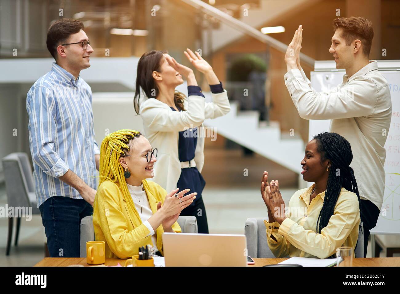 cheerful active ambitious people congratulating each other, booming ...
