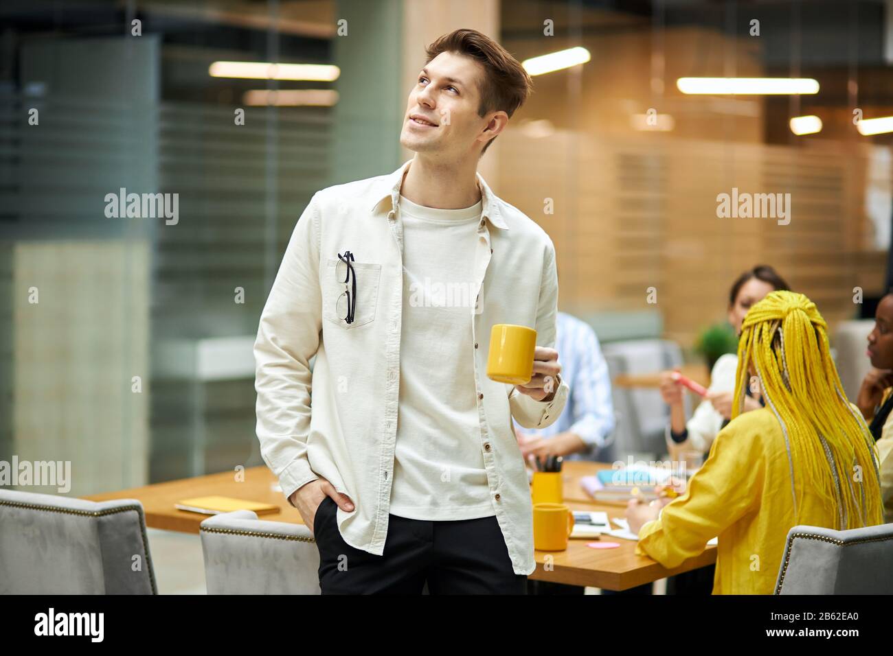 cheerful positive attractive man looking up, man never gives up ...