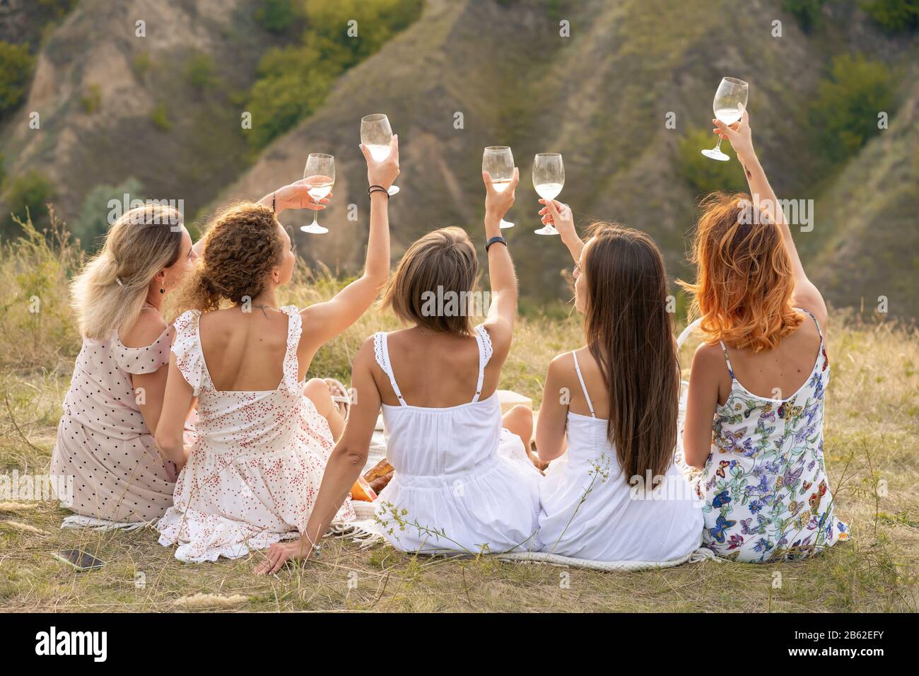 Shoot from back. The company of gorgeous female friends having fun ...