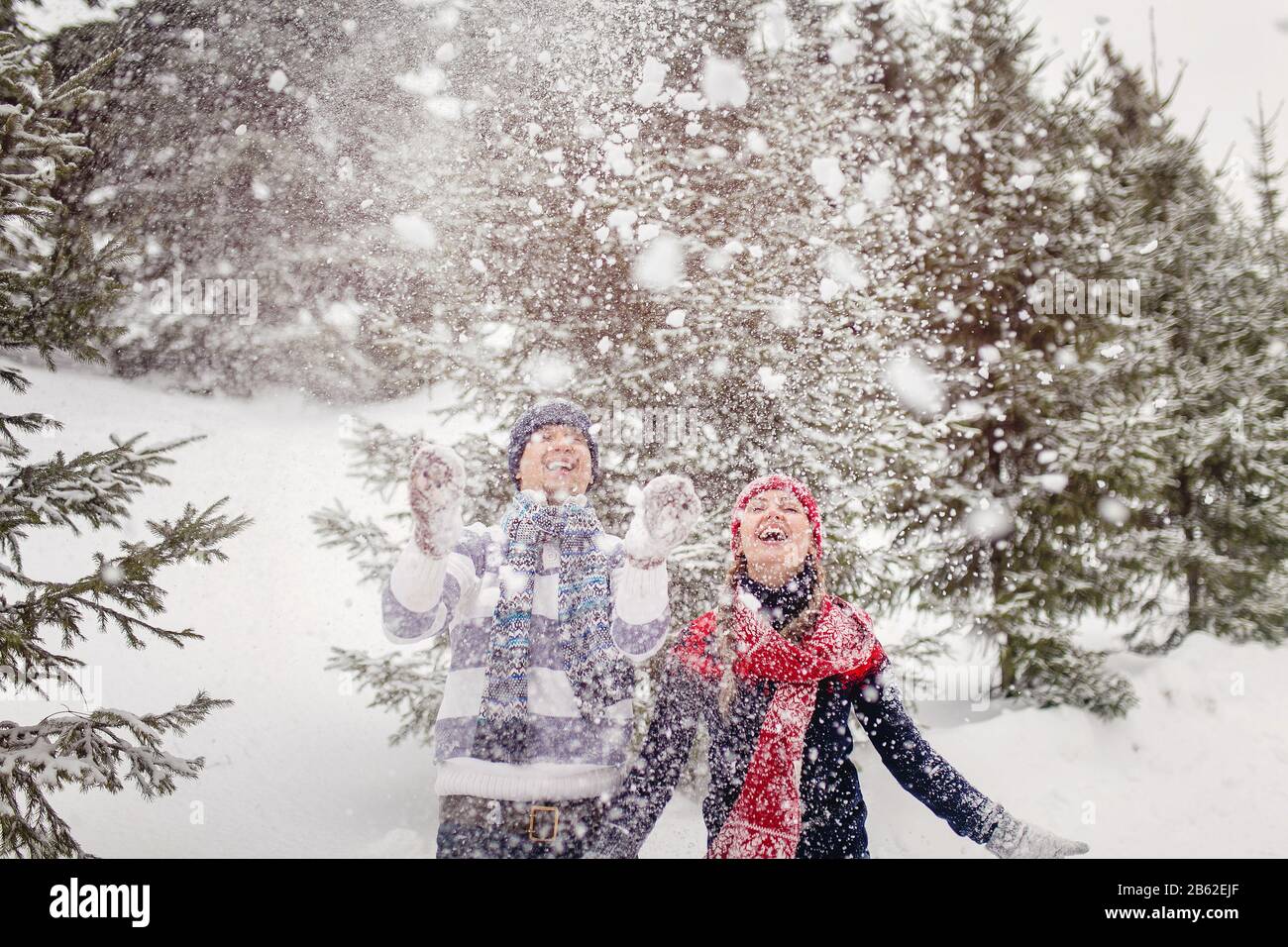 Smiling friends playing snow hi-res stock photography and images - Alamy