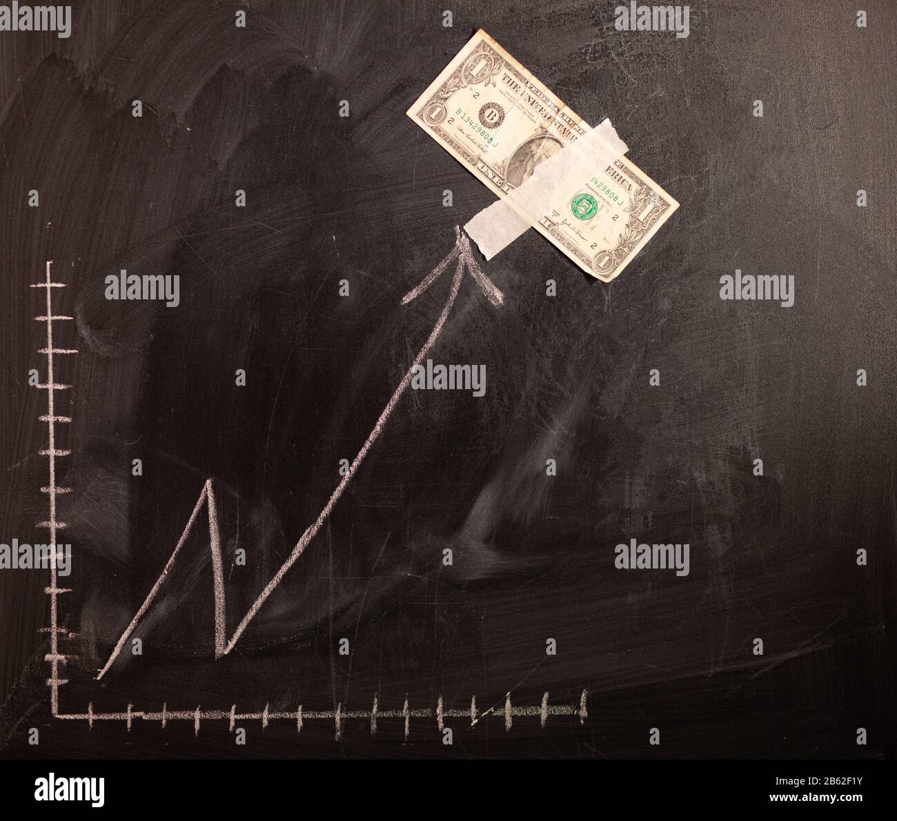 Dollar growth chart drawn on chalkboard. Investment concepts and ...