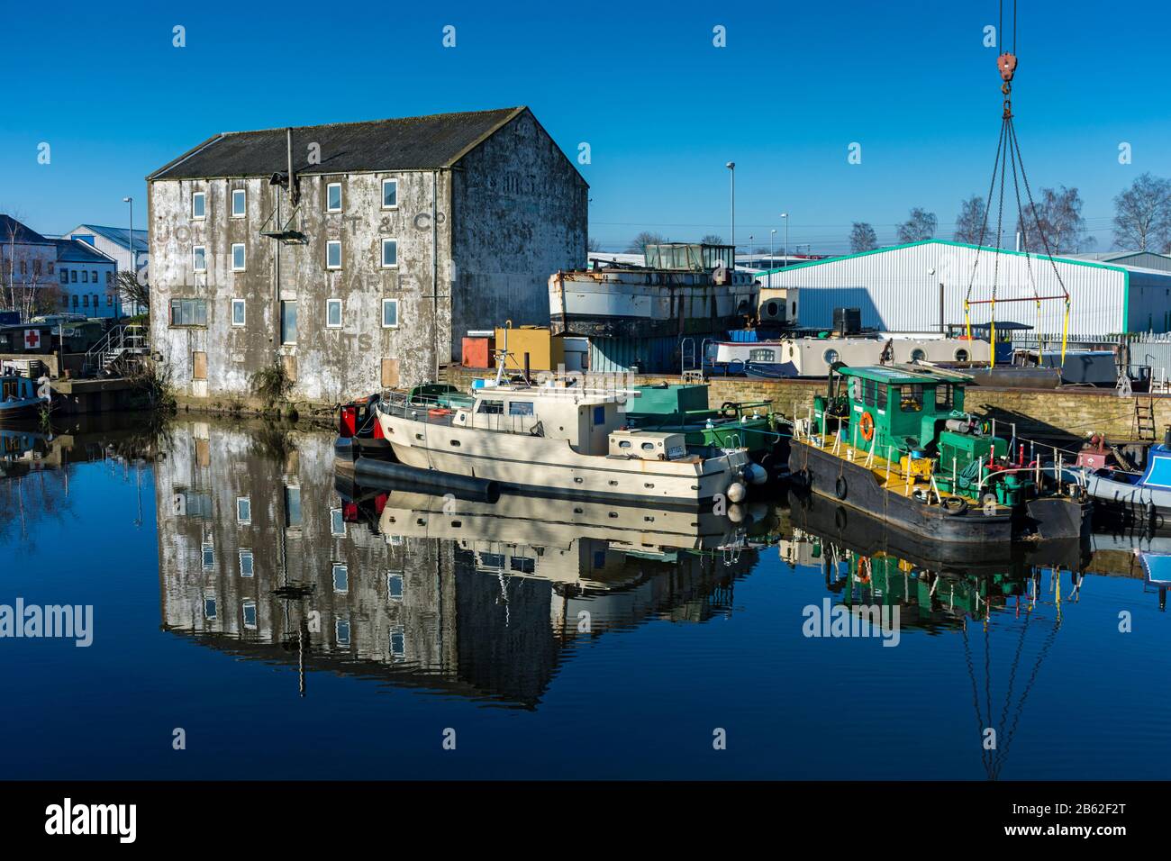 An old mill and moored boats at Wakefield Wharf and Boatyard, on the ...