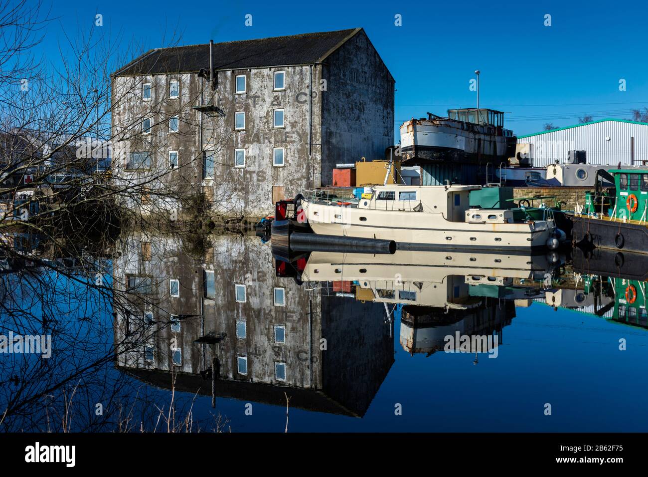 An old mill and moored boats at Wakefield Wharf and Boatyard, on the ...