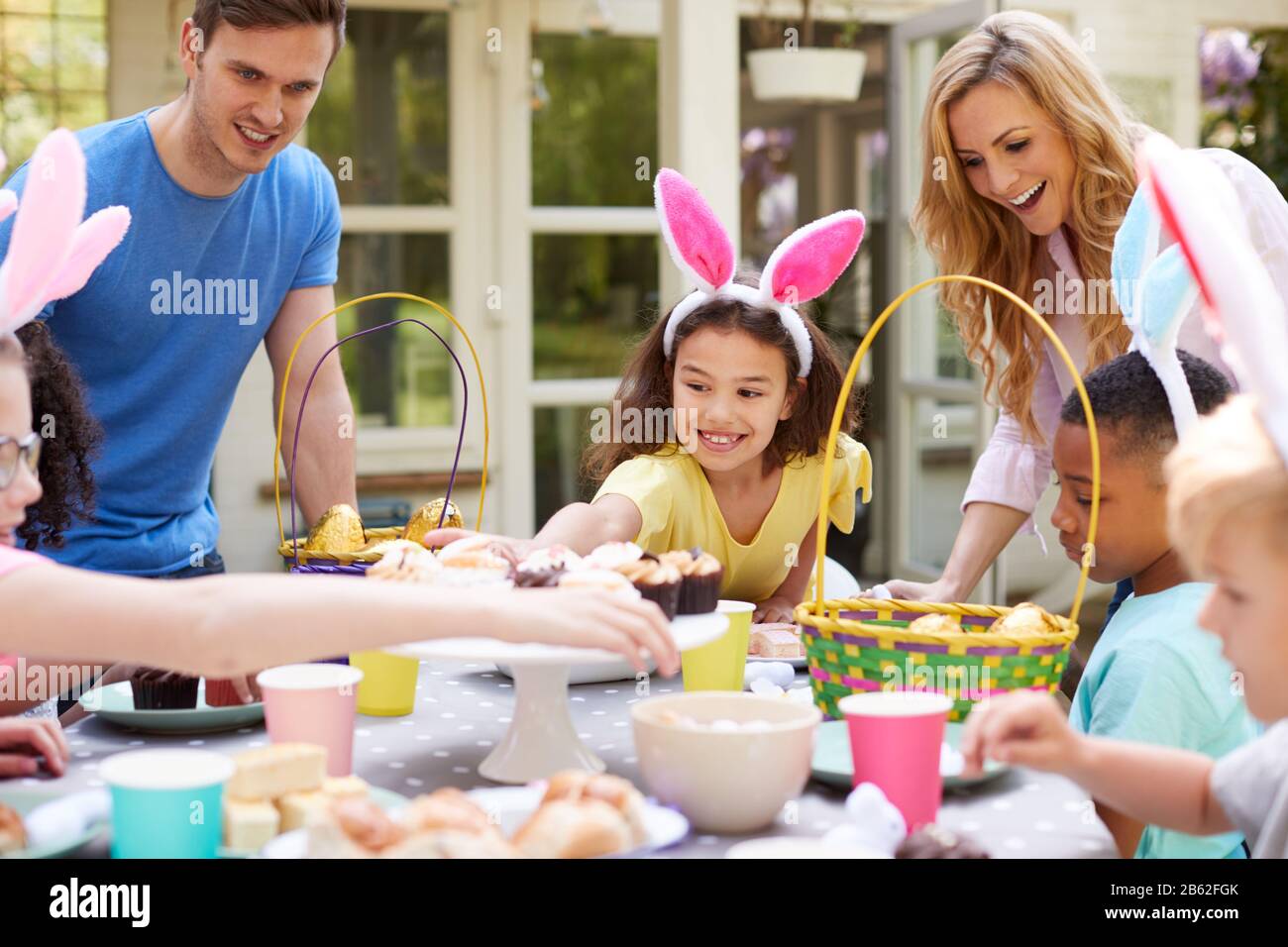 Parents With Children Wearing Bunny Ears Enjoying Outdoor Easter Party ...