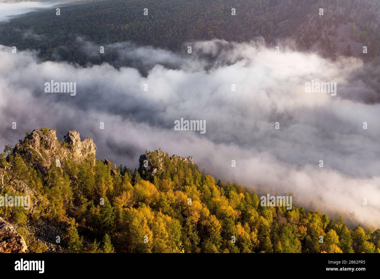 The high cliff in mist on sunrise background Stock Photo - Alamy